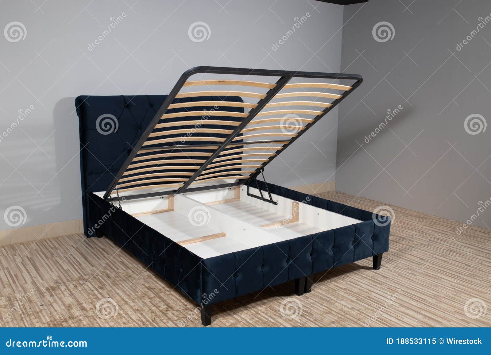 Dark Blue Bed with a Storage Space Revealed by Lifting the Wooden ...