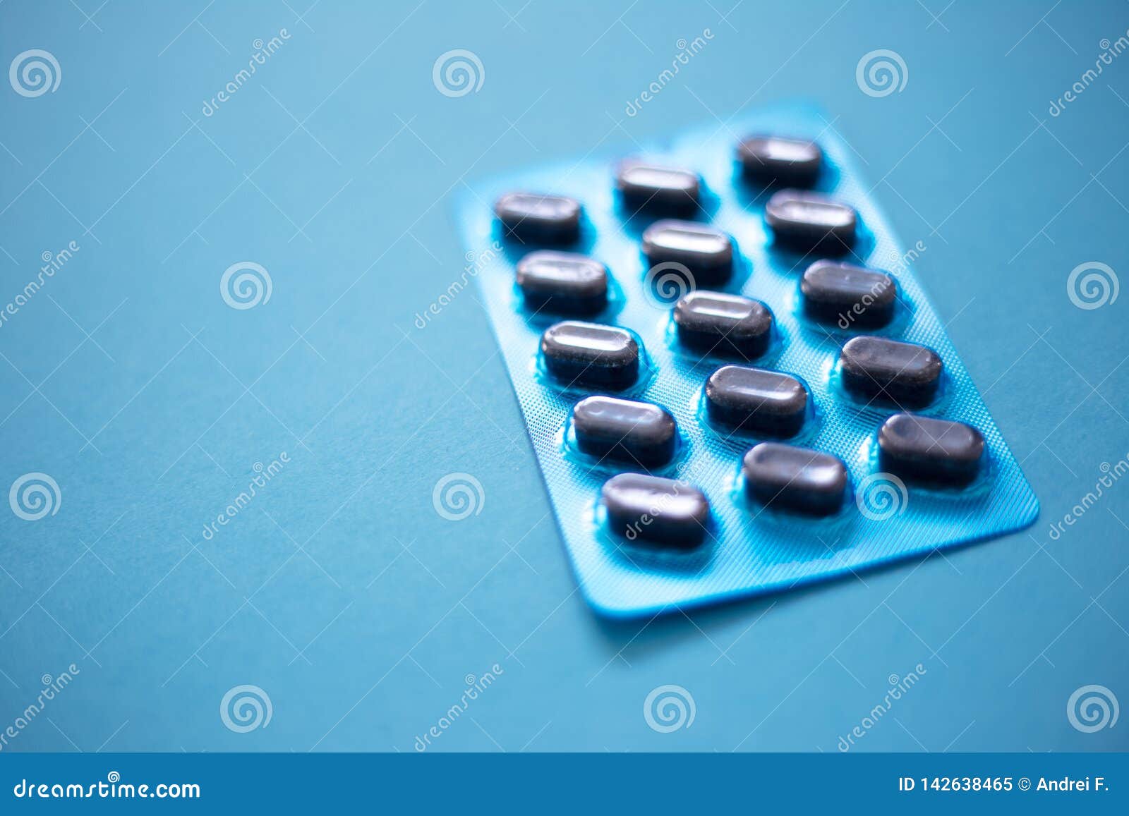 Dark Blue Medicine Pills on the Blue Background. Stock Image - Image of ...