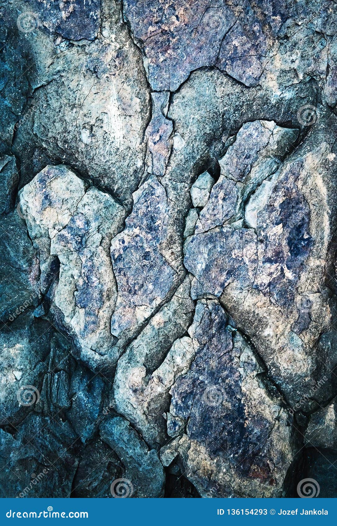 Dark blue rock with cracks stock image. Image of level - 136154293