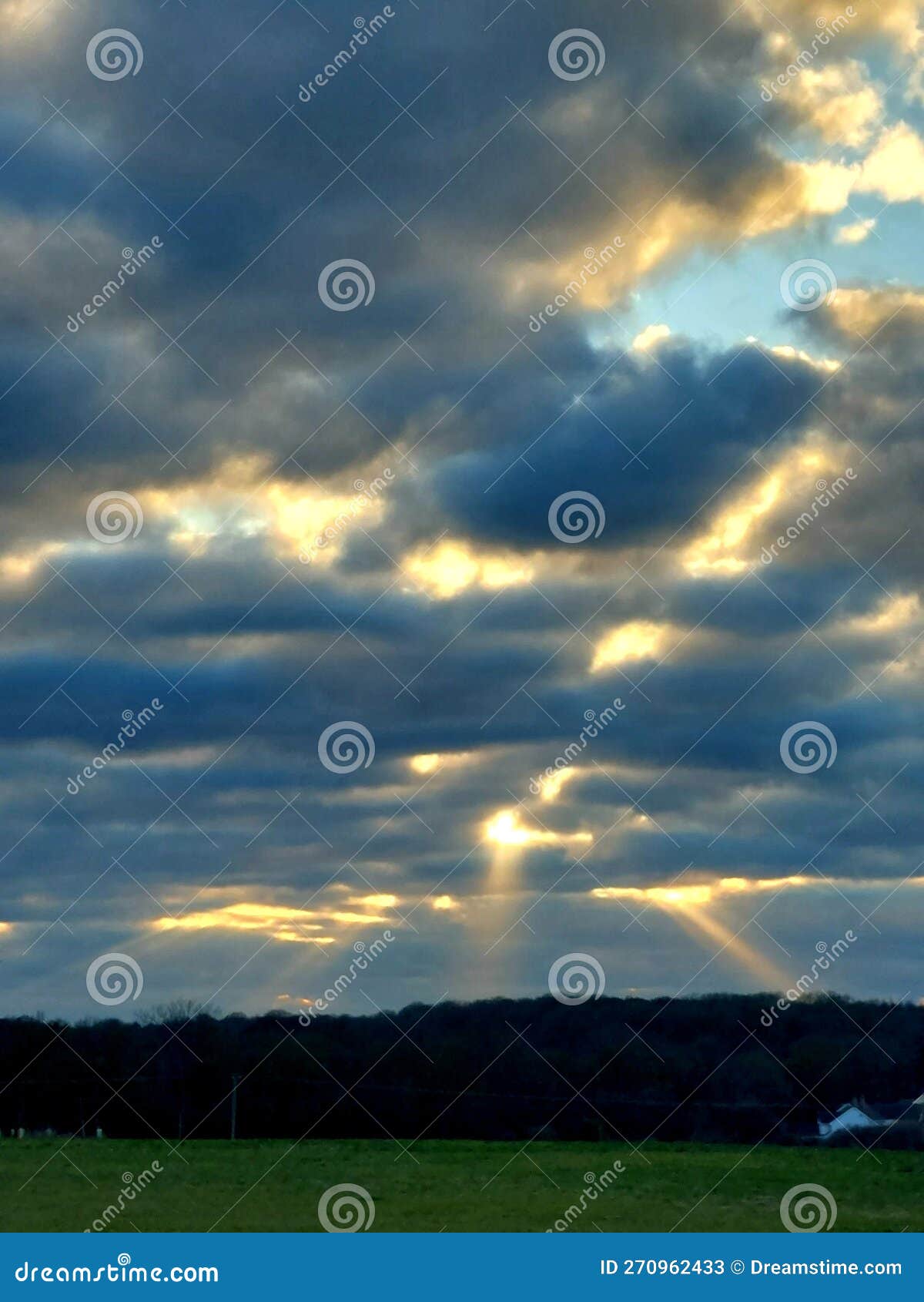 Dark Clouds Crowd the Setting Sun but Sunbeams Break through Stock ...