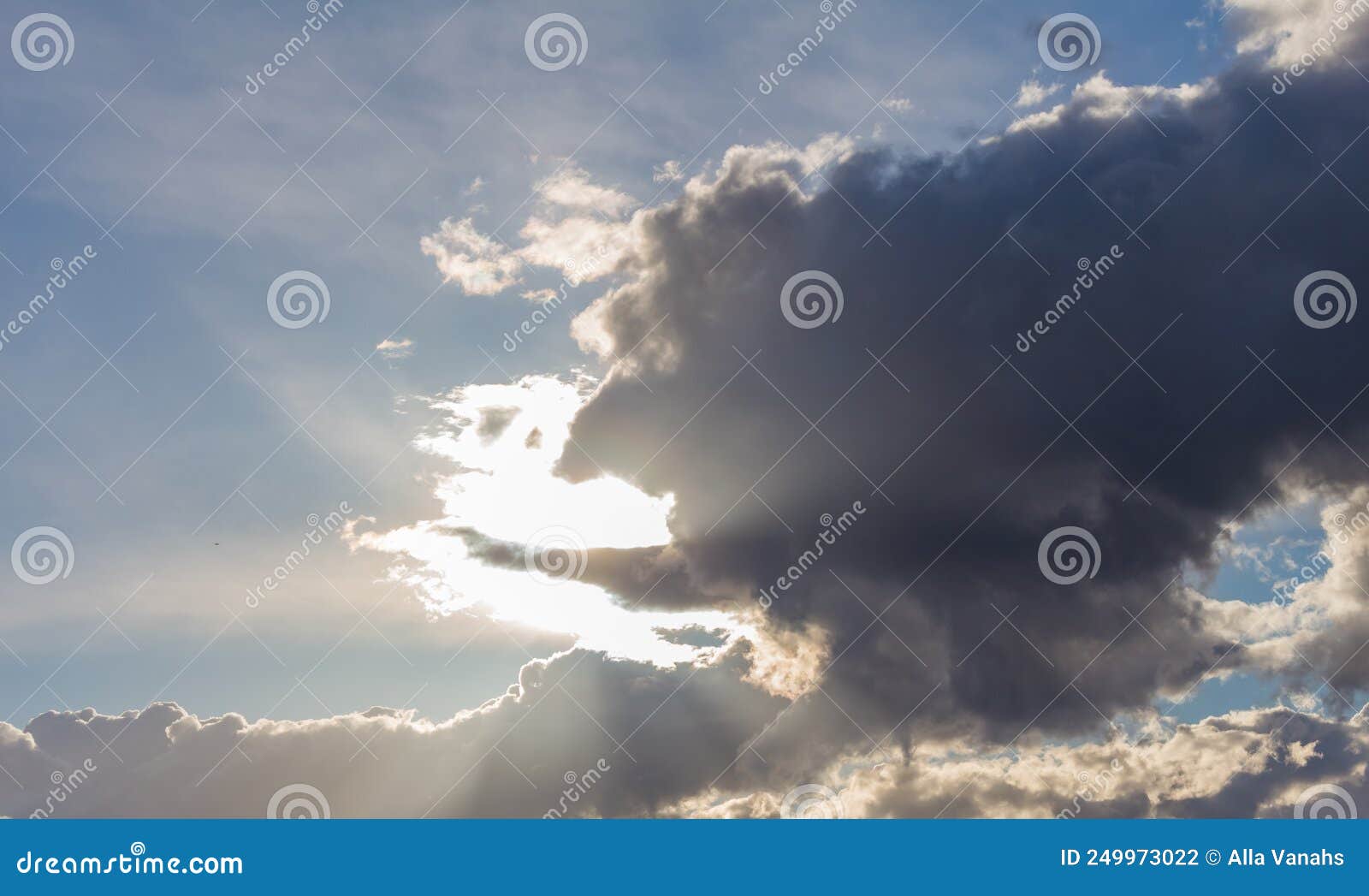 Dark clouds and sun rays stock photo. Image of scene - 249973022
