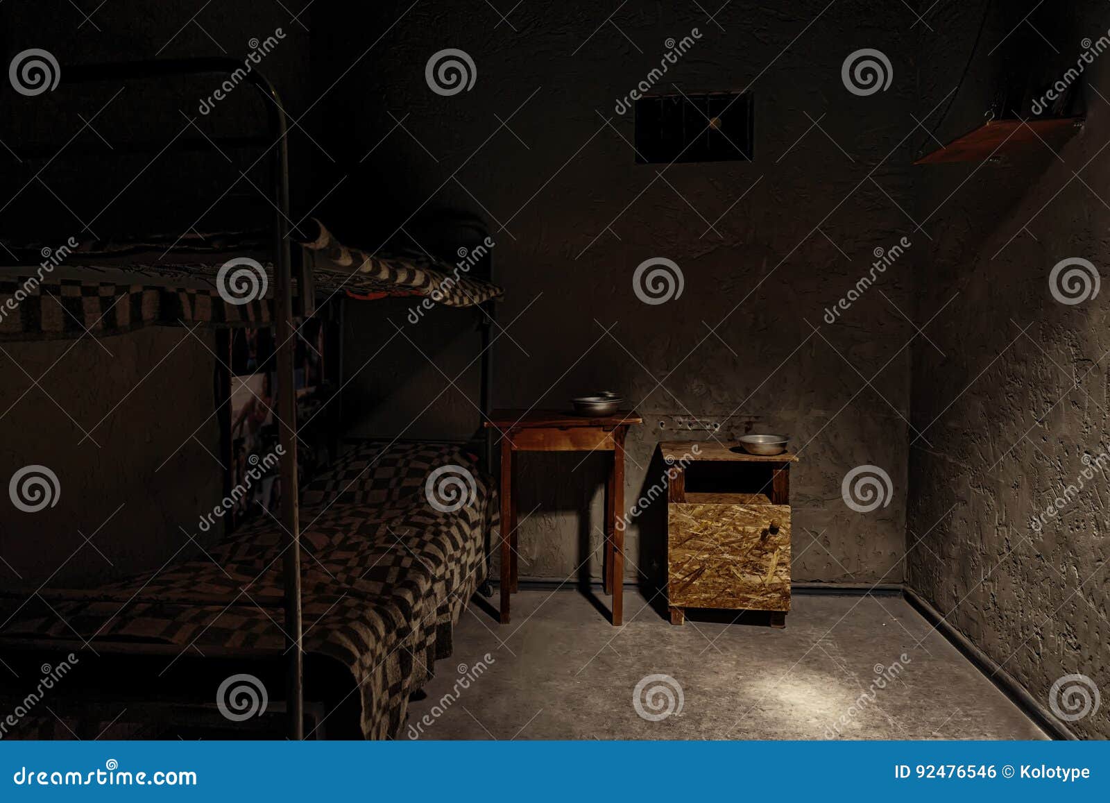 A Dark Empty Prison Cell with Iron Bunk Bed and Bedside Table Stock ...