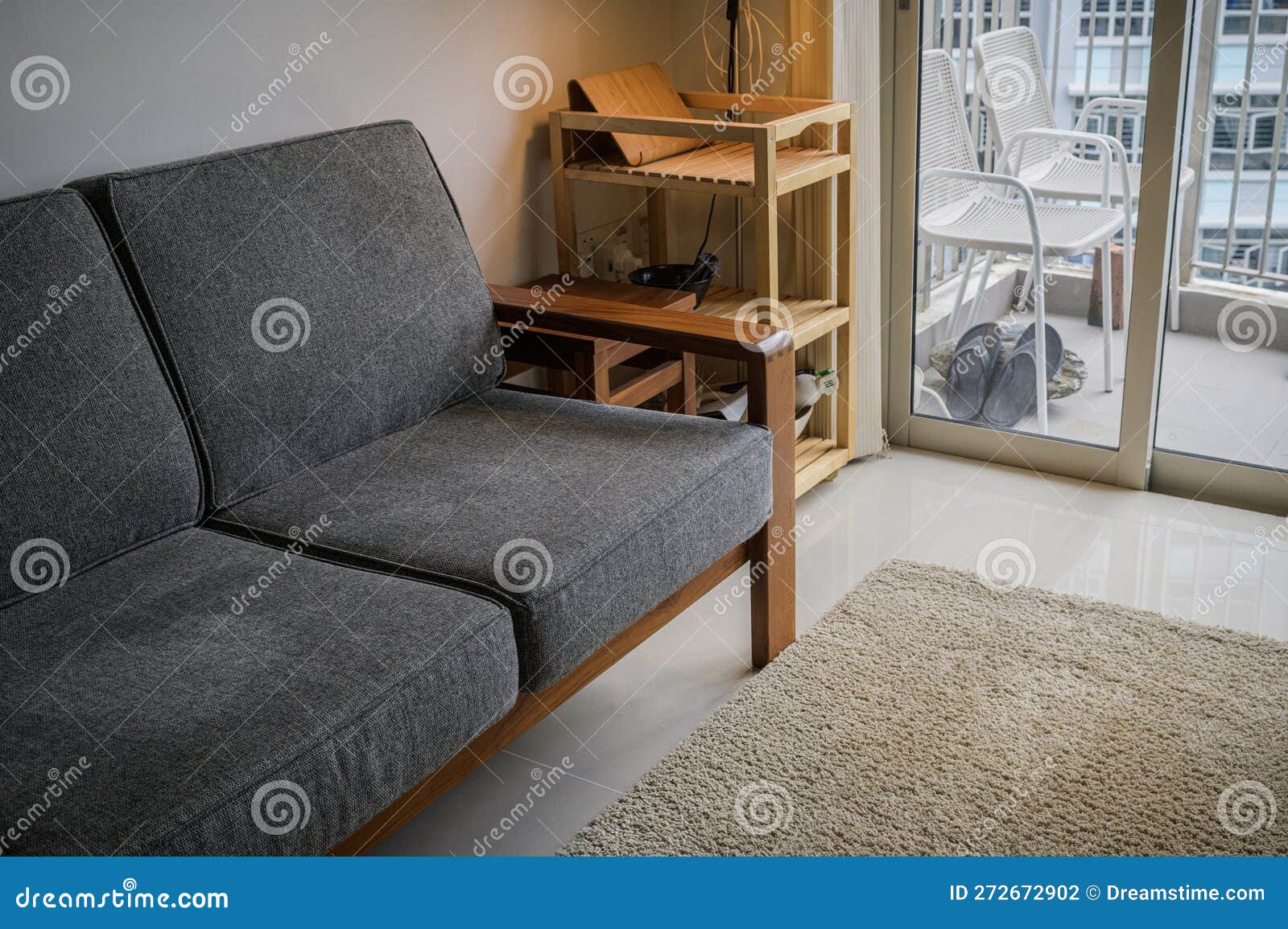 A Dark Grey Sofa by the Corner of Balcony Window in HDB Apartment ...