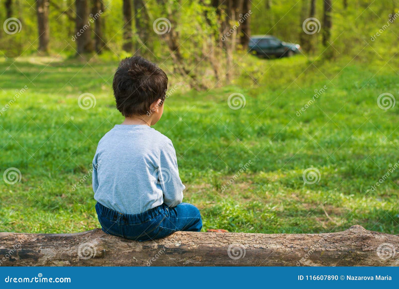 Lonely Boy Sitting on a Log Stock Photo - Image of solitude, wood ...