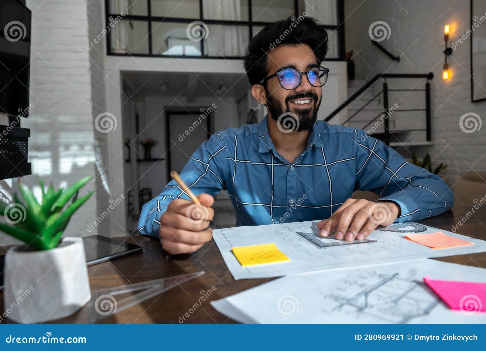 Dark-haired Young Man Sitting at the Table and Preparing a Project ...