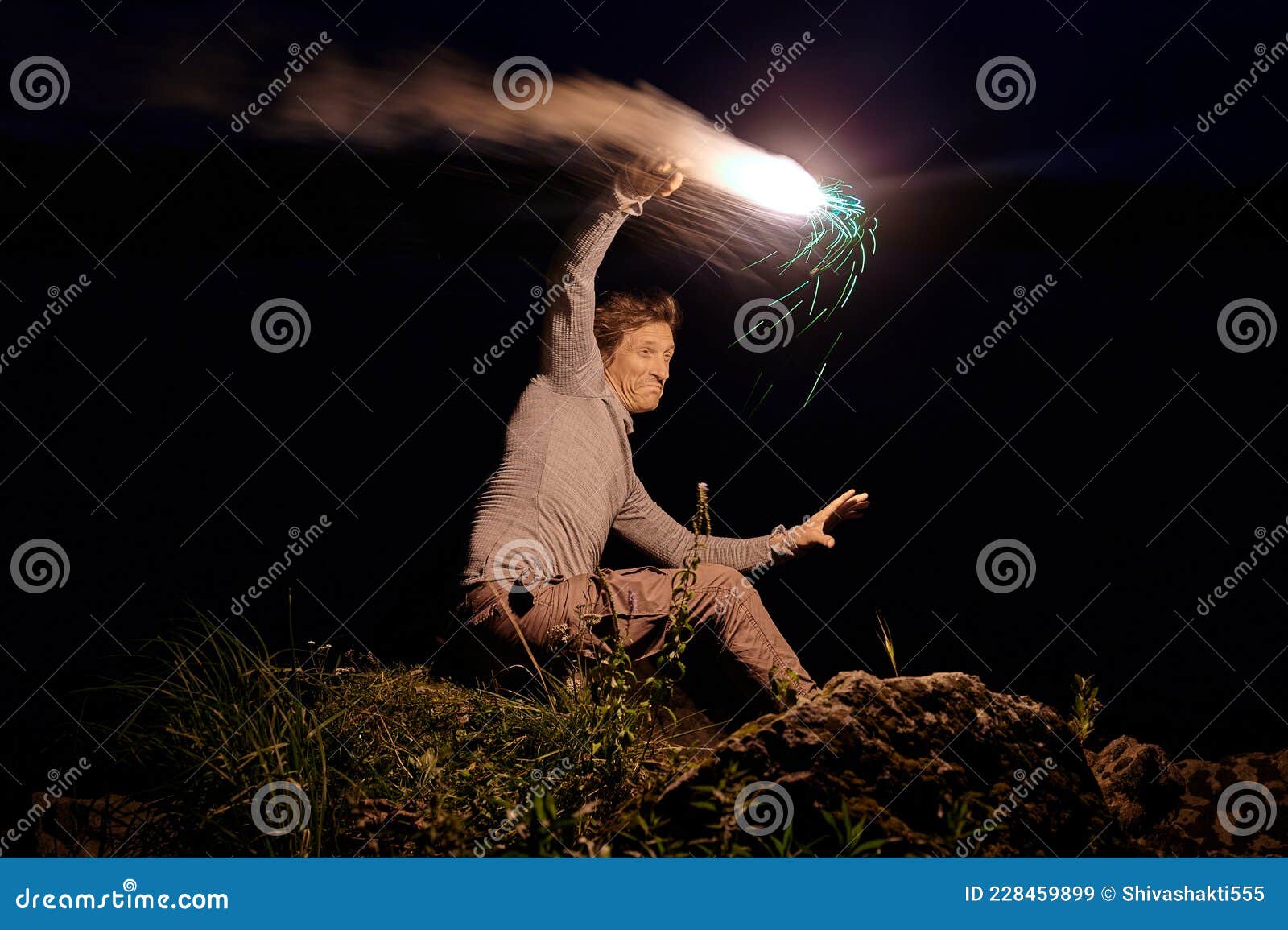 The man with fireworks in stock image. Image of hides - 228459899