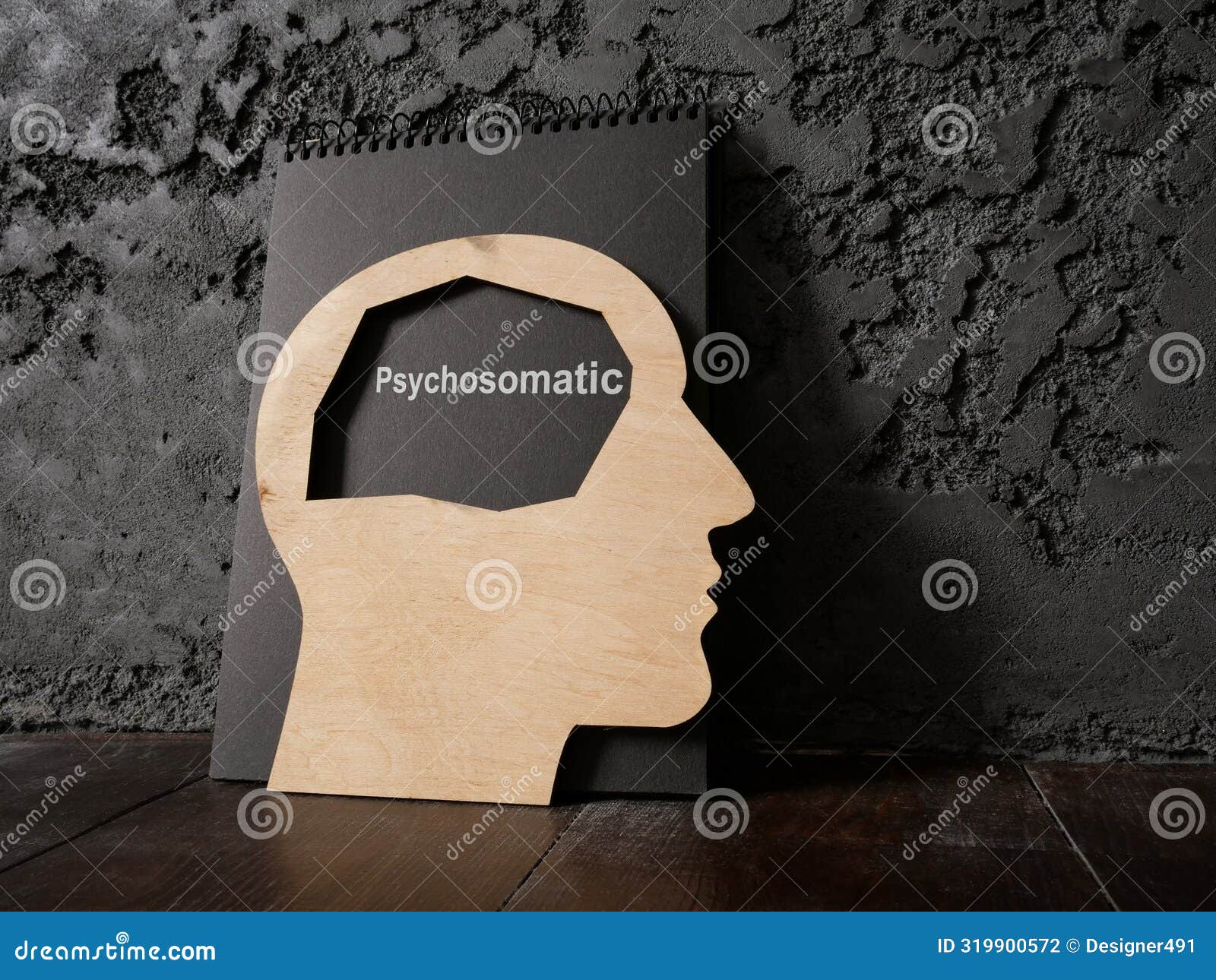 A Dark Notepad with an Inscription Psychosomatic and an Outline of a ...