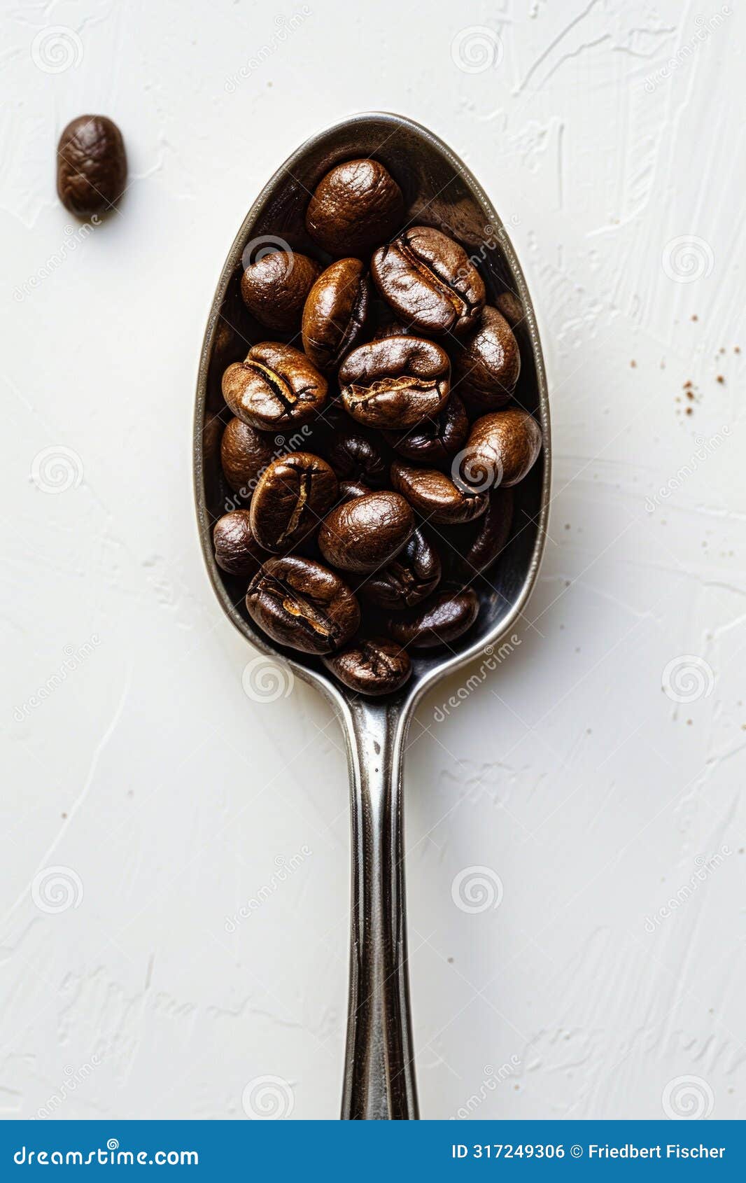 Dark Roasted Coffee Beans in Silver Spoon on Textured White Surface ...