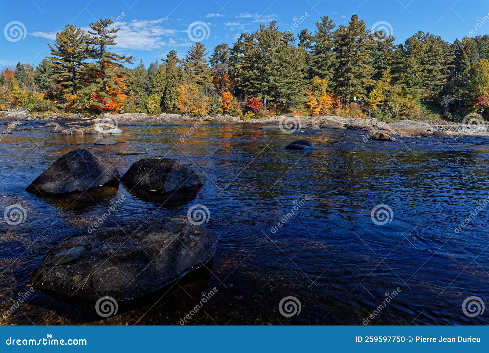 Dark Rocks on the River and Fall Colors on Forest Stock Photo - Image ...