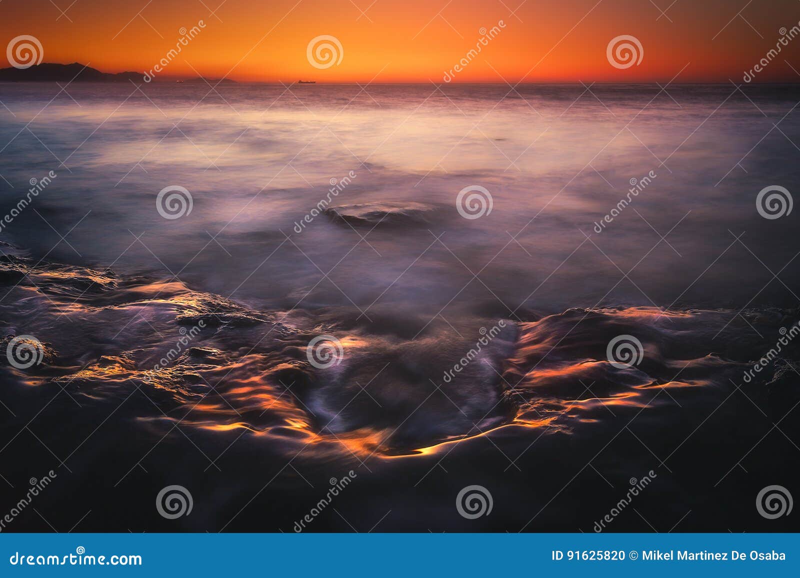 Dark Seascape with Sunset Reflections on Rocks Stock Photo - Image of ...