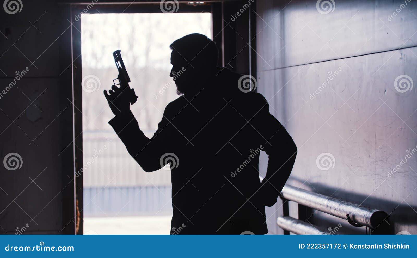 The Dark Silhouette of the Man Pulls the Shutter of the Gun and Goes ...