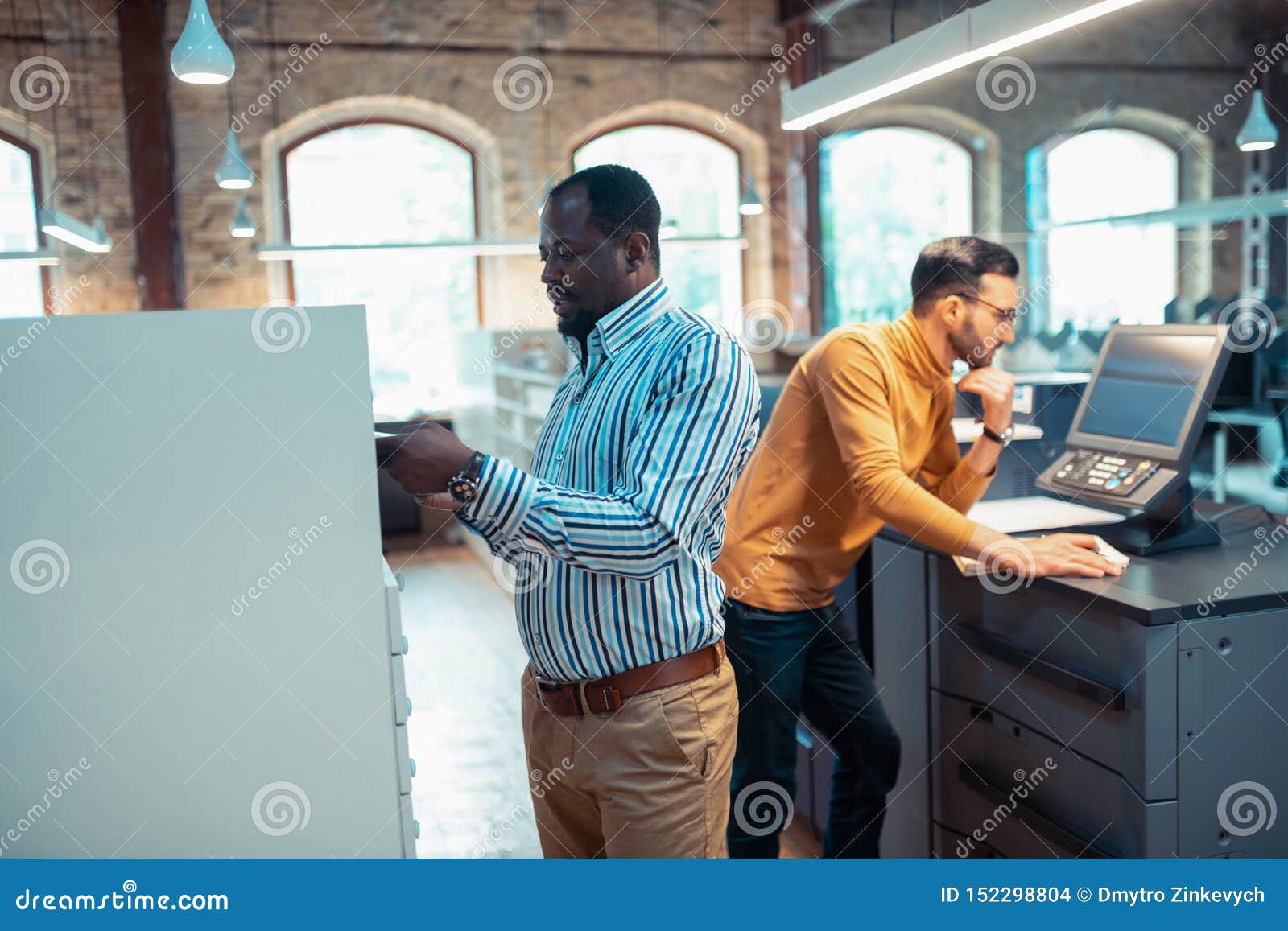 Dark-skinned Publisher Feeling Busy Working in Printing Office Stock ...