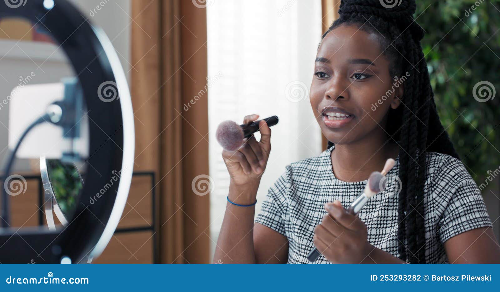 A Dark-skinned Woman with Braids Tied in a Ponytail Records Short ... A Dark-skinned Woman with Braids Tied in a Ponytail Records Short ...