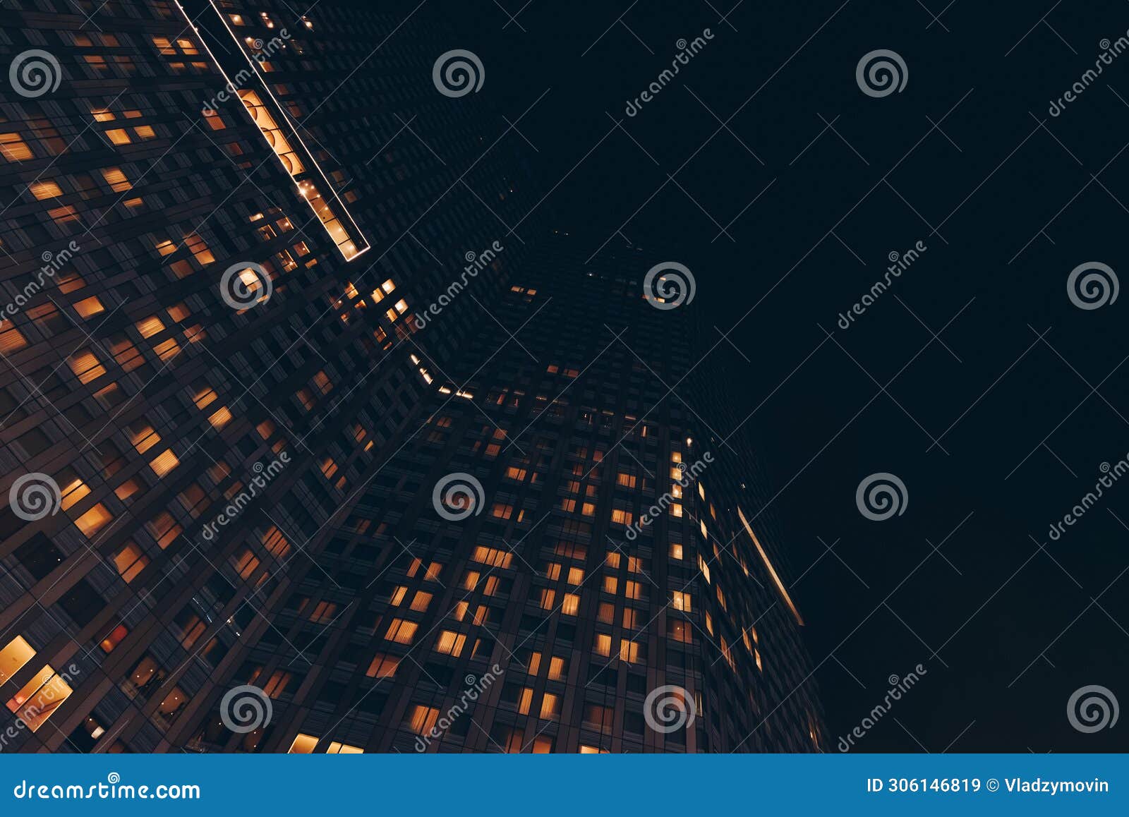 Dark Skyscraper with Warm Light in the Windows Stock Image - Image of ...
