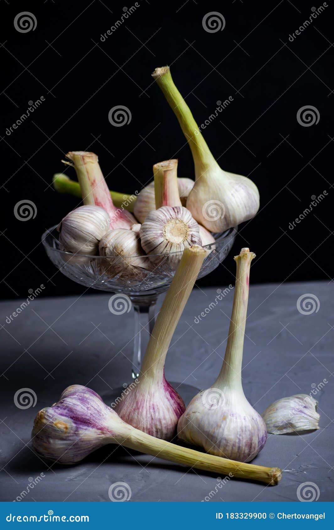 Dark Still Life with Garlic in a Glass Vase on Dark Background Stock ...
