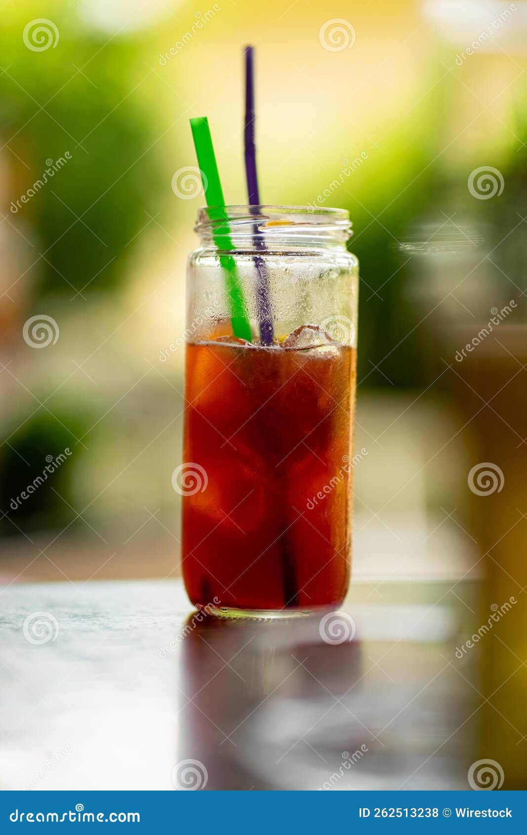 Dark Stormy Cocktail with Ice Cubes in a Tall Jar Put Outside on the ...