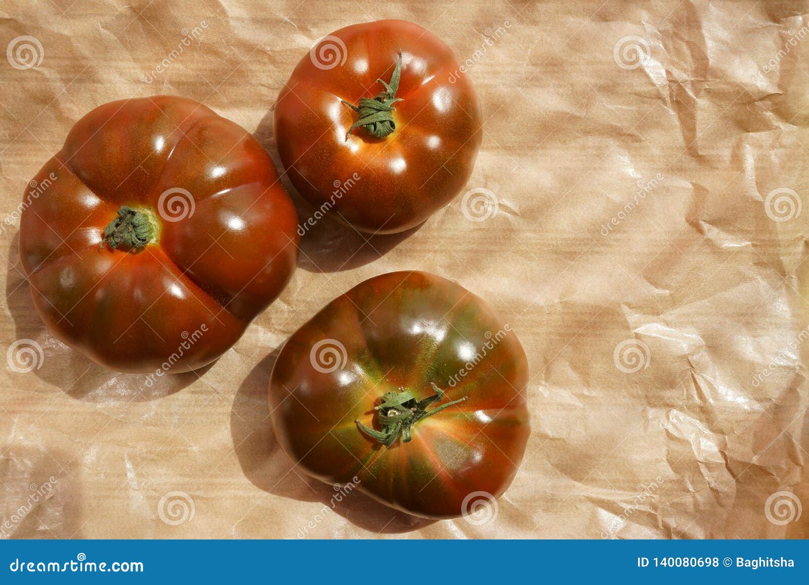 Dark Tomatoes on Crumpled Kraft Paper Stock Photo - Image of tabletop ...