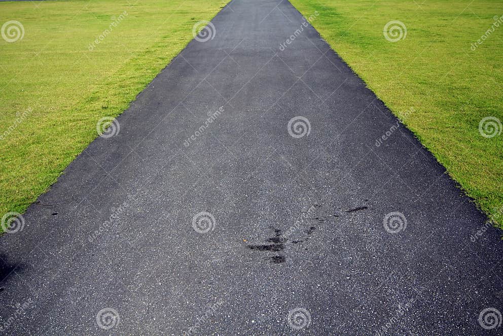 Dark Walkway in a Green Grass Stock Photo - Image of pavement, park ...