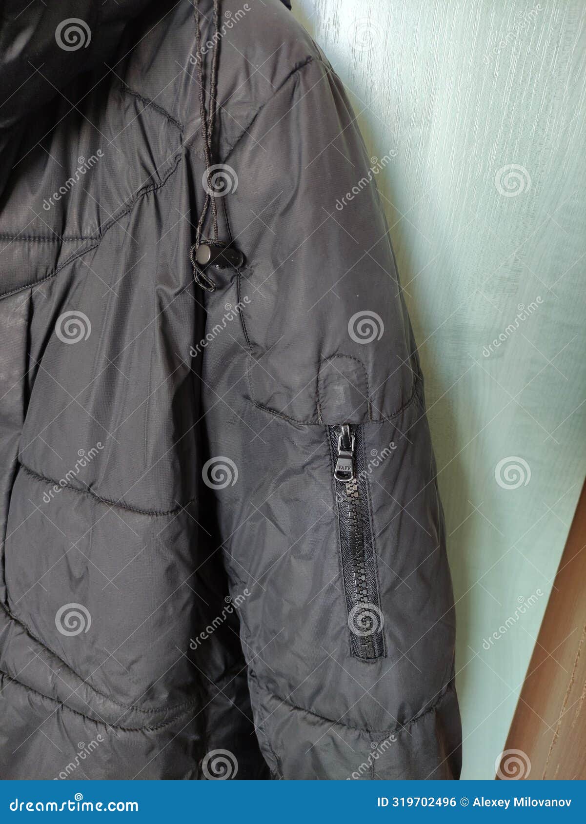 Dark Winter Jacket Hanging on a Hanger on the Closet Door Stock Photo ...