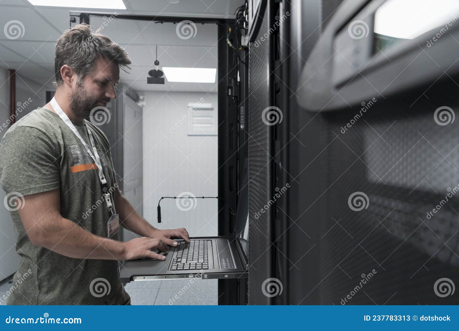 Data Center Engineer Usaing Keyboard on a Supercomputer Server Room ...