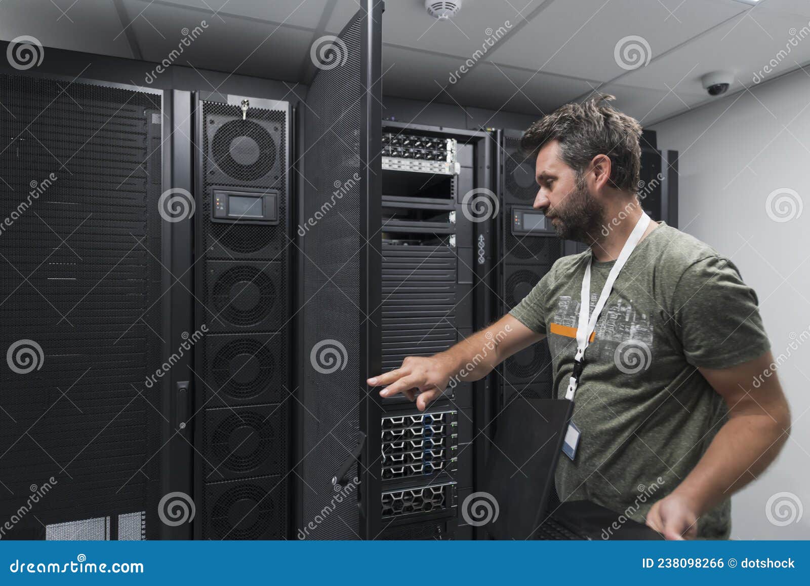 Data Center Engineer Usaing Keyboard on a Supercomputer Server Room ...