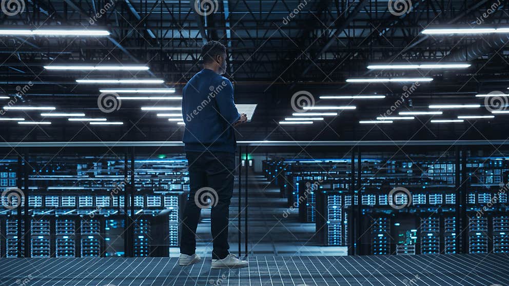 Data Center Engineer Using Laptop Computer. Server Farm Cloud Computing ...
