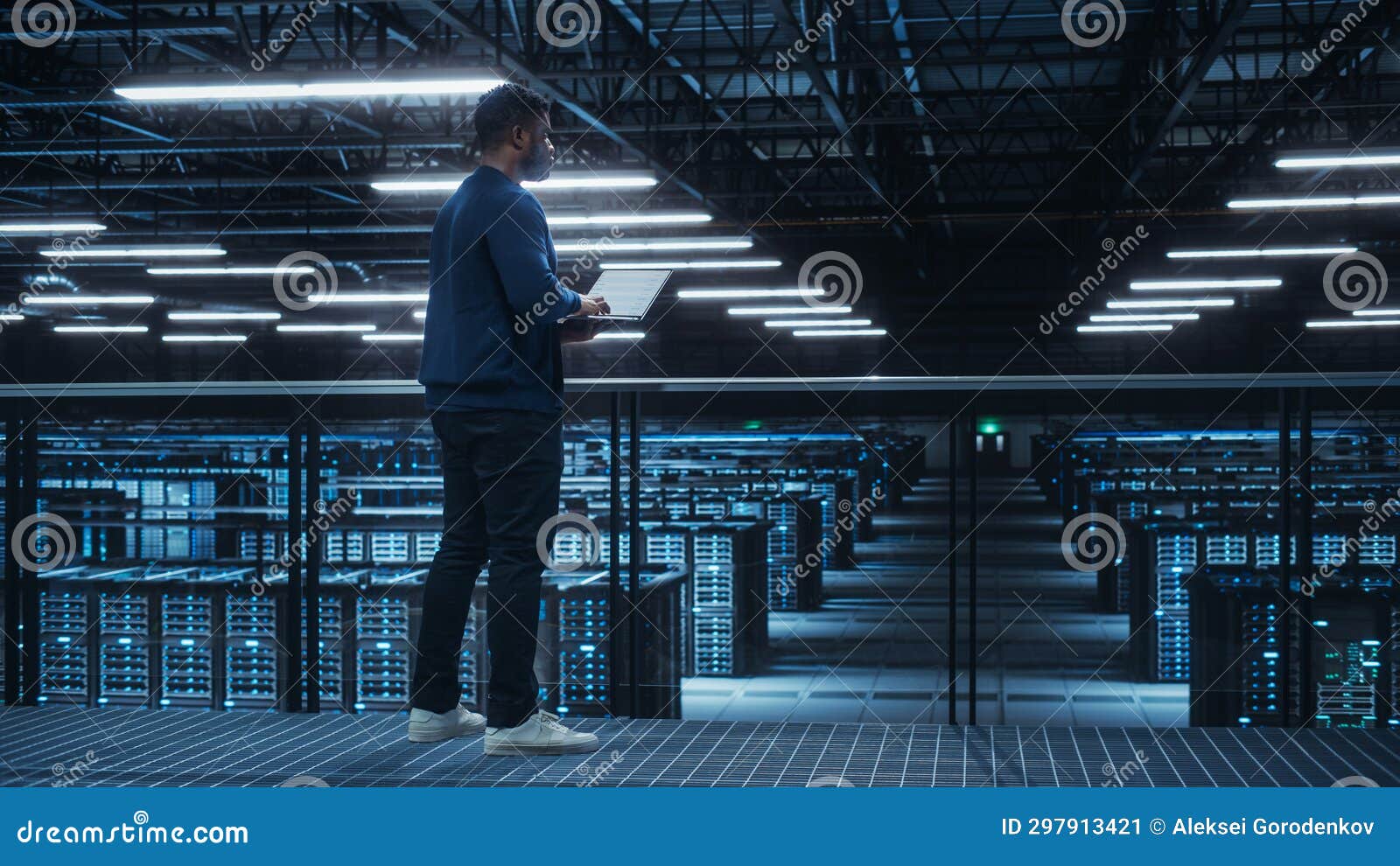 Data Center Engineer Using Laptop Computer. Server Farm Cloud Computing Specialist Facility with ...