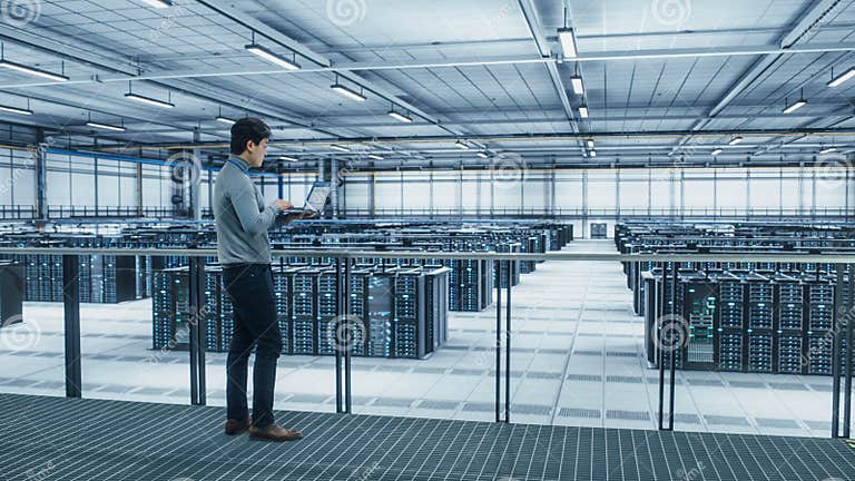 Data Center Engineer Using Laptop Computer. Server Farm Cloud Computing ...