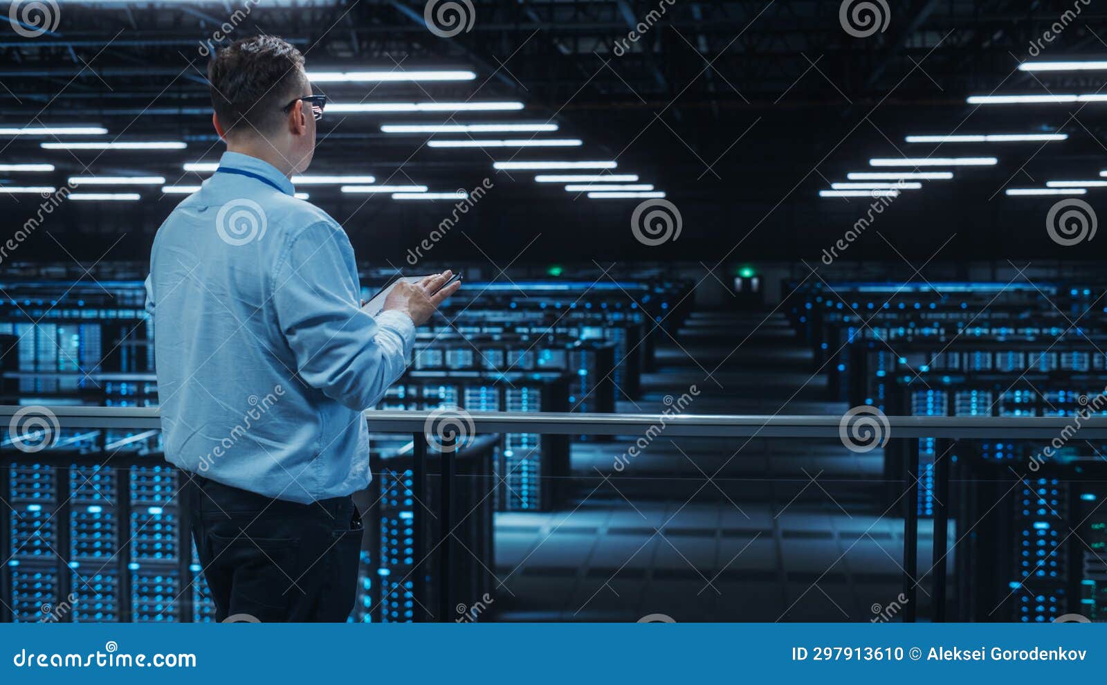 Data Center Engineer Using Laptop Computer. Server Farm Cloud Computing Specialist Facility with ...