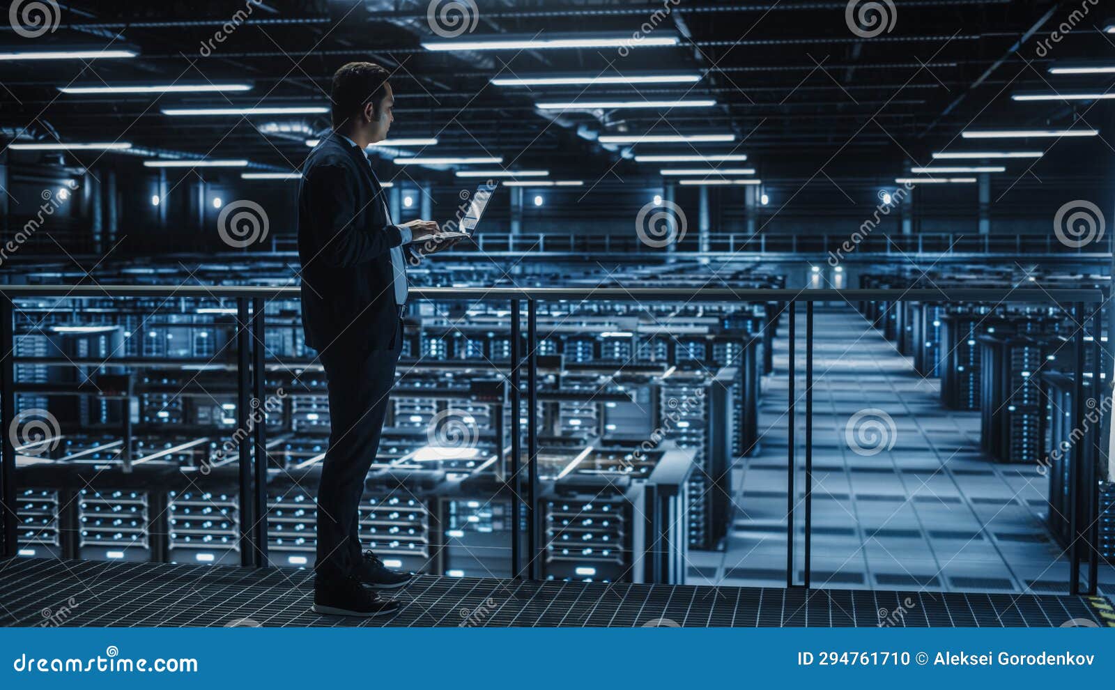 Data Center Male Administrator Using Laptop Computer. Cloud Computing ...