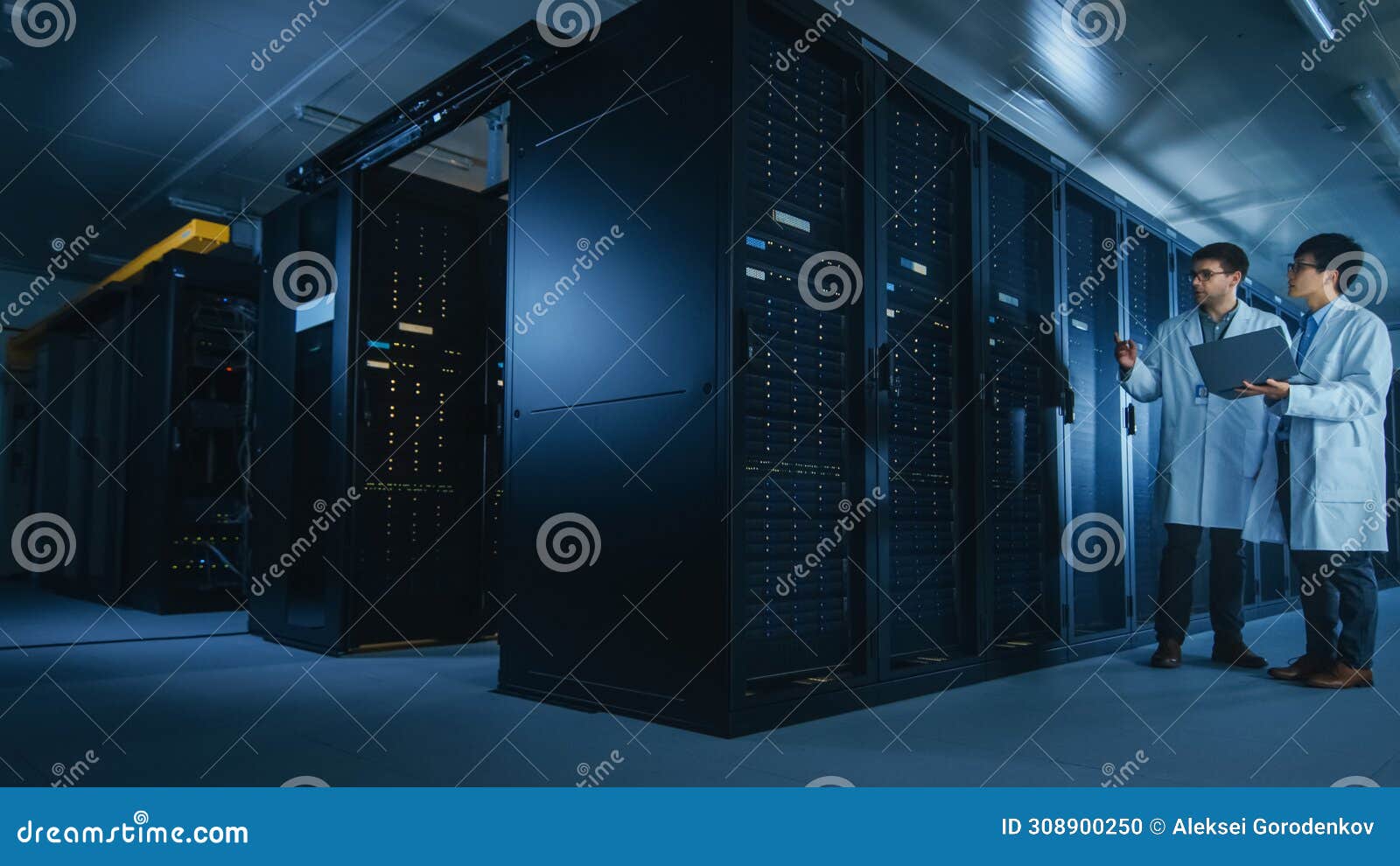 In the Data Center: Two it Specialists Wearing White Lab Coats, Have ...
