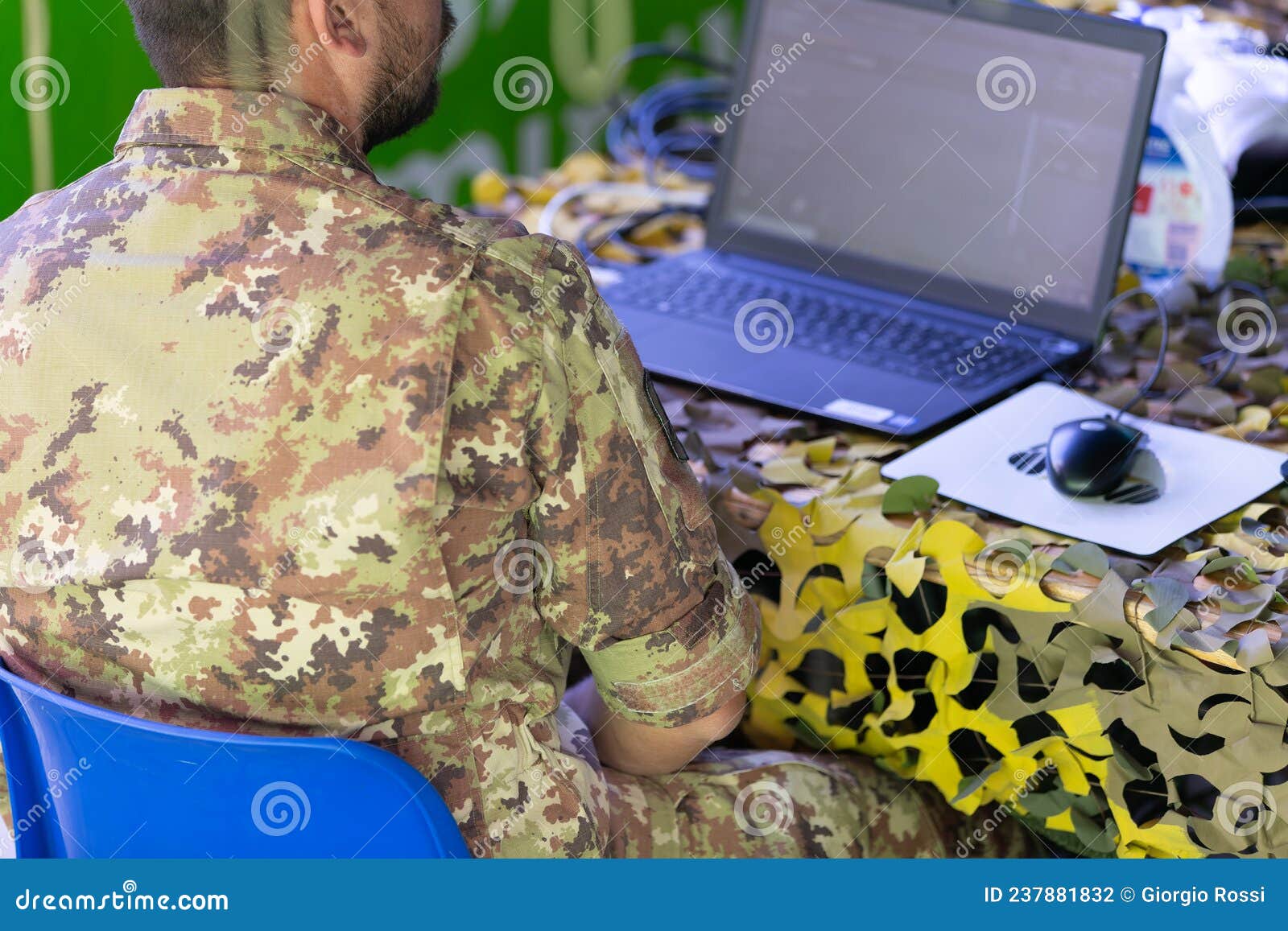 Data Entry Soldier with a Laptop in Front of Him Inside a Military Camp ...