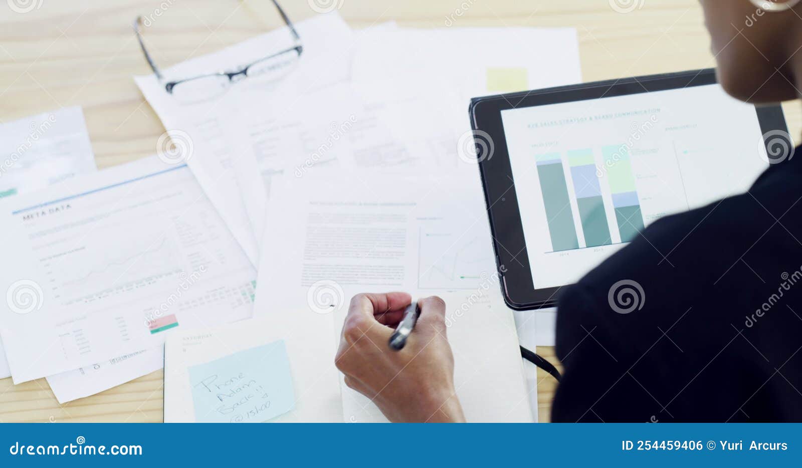 Data, Finance and Graph with an Accountant Writing on a Document in Her ...