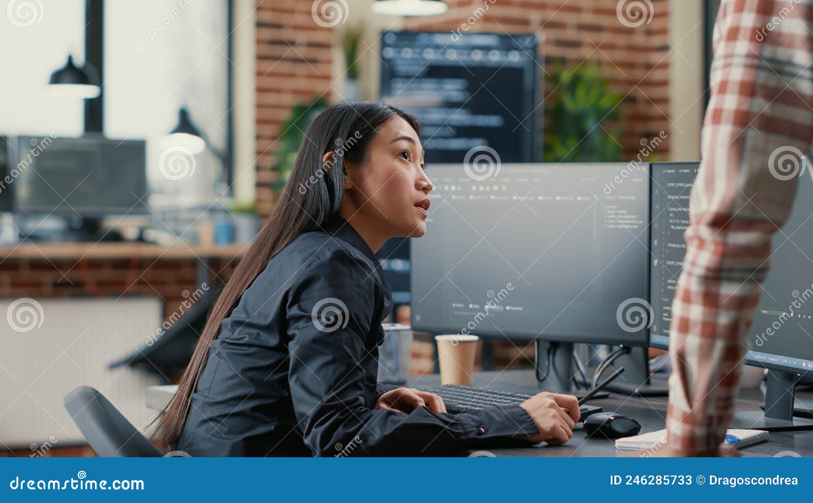 Database Developer Pointing Pencil At Computer Screen With Software Compiling Code Explaining
