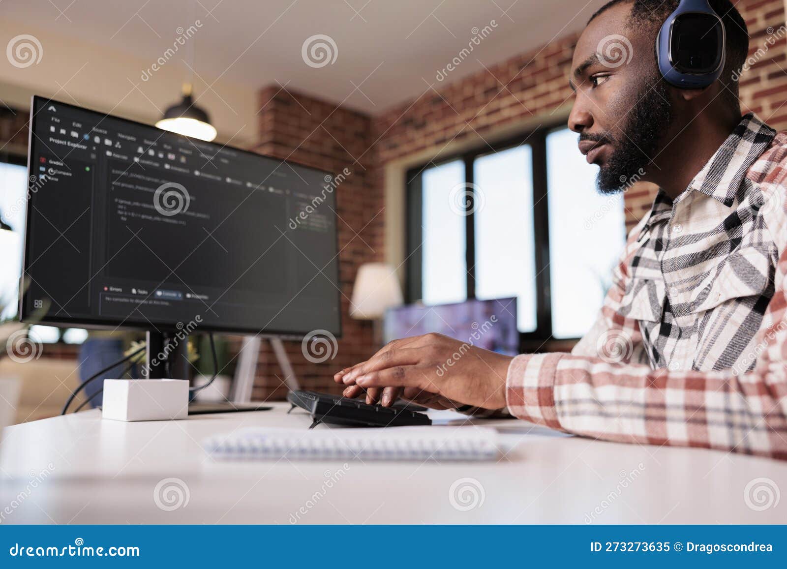 Database Developer With Wireless Headphones Programming Algorithm Using Personal Computer Stock 6908
