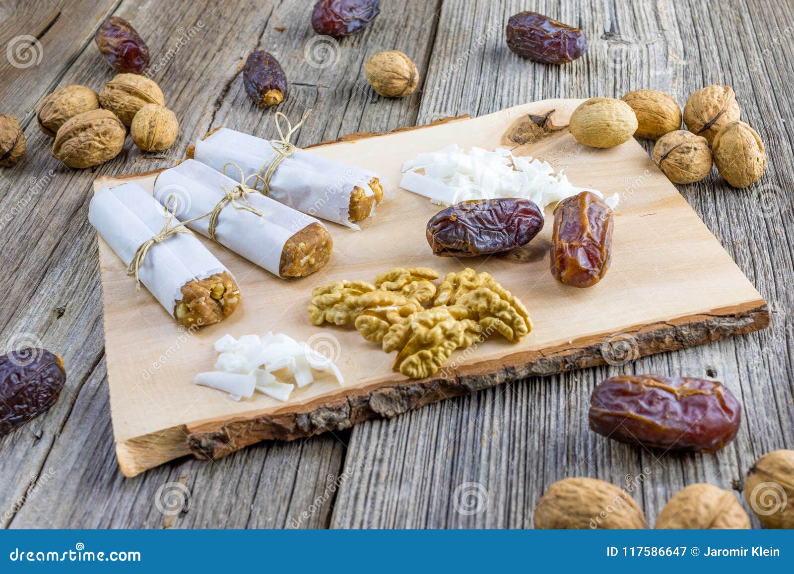 Dates Bar Wrapped in Paper with Walnuts and Coconut on a Wooden Stock ...