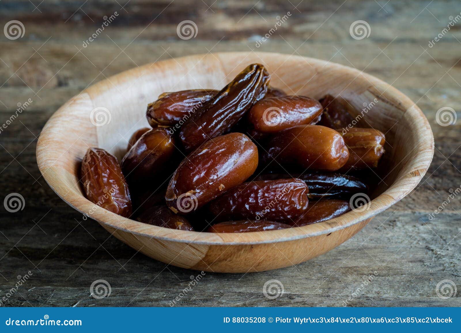 Dates in a bowl stock photo. Image of wooden, table, food - 88035208