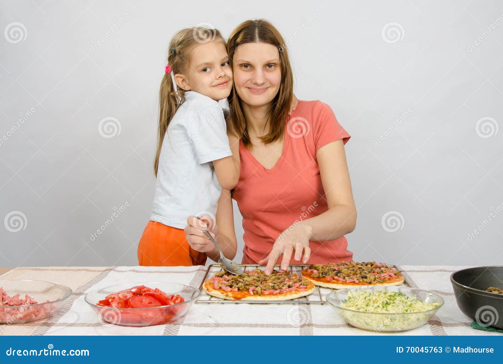 Daughter Hugging Her Mother, Which Makes Pizza Stock Image - Image of ...
