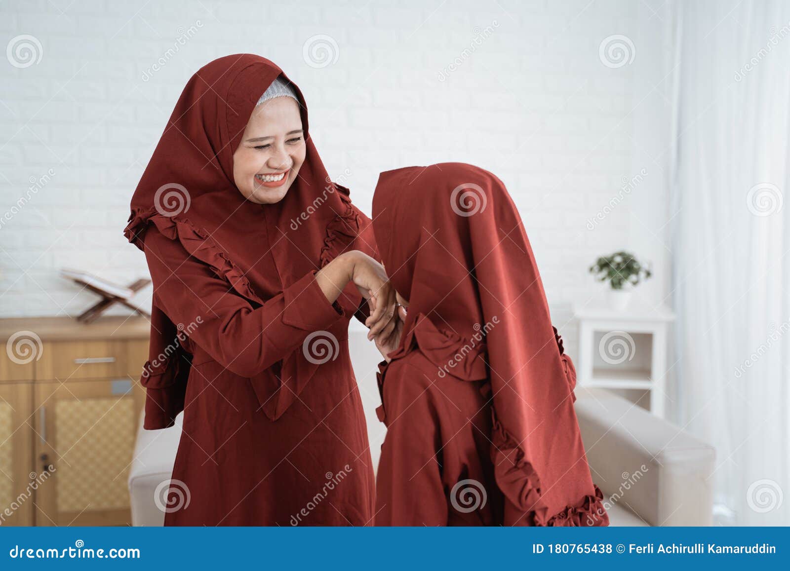 A Daughter Kissing His Mother`s Hand When Celebrating Happy Eid Mubarak