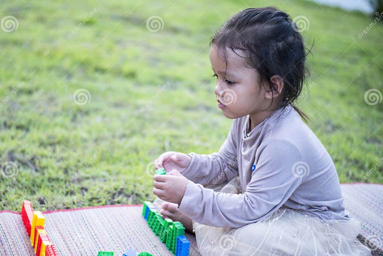 Daughter and Mother Playing with Legos on the Front Yard. Concept of ...