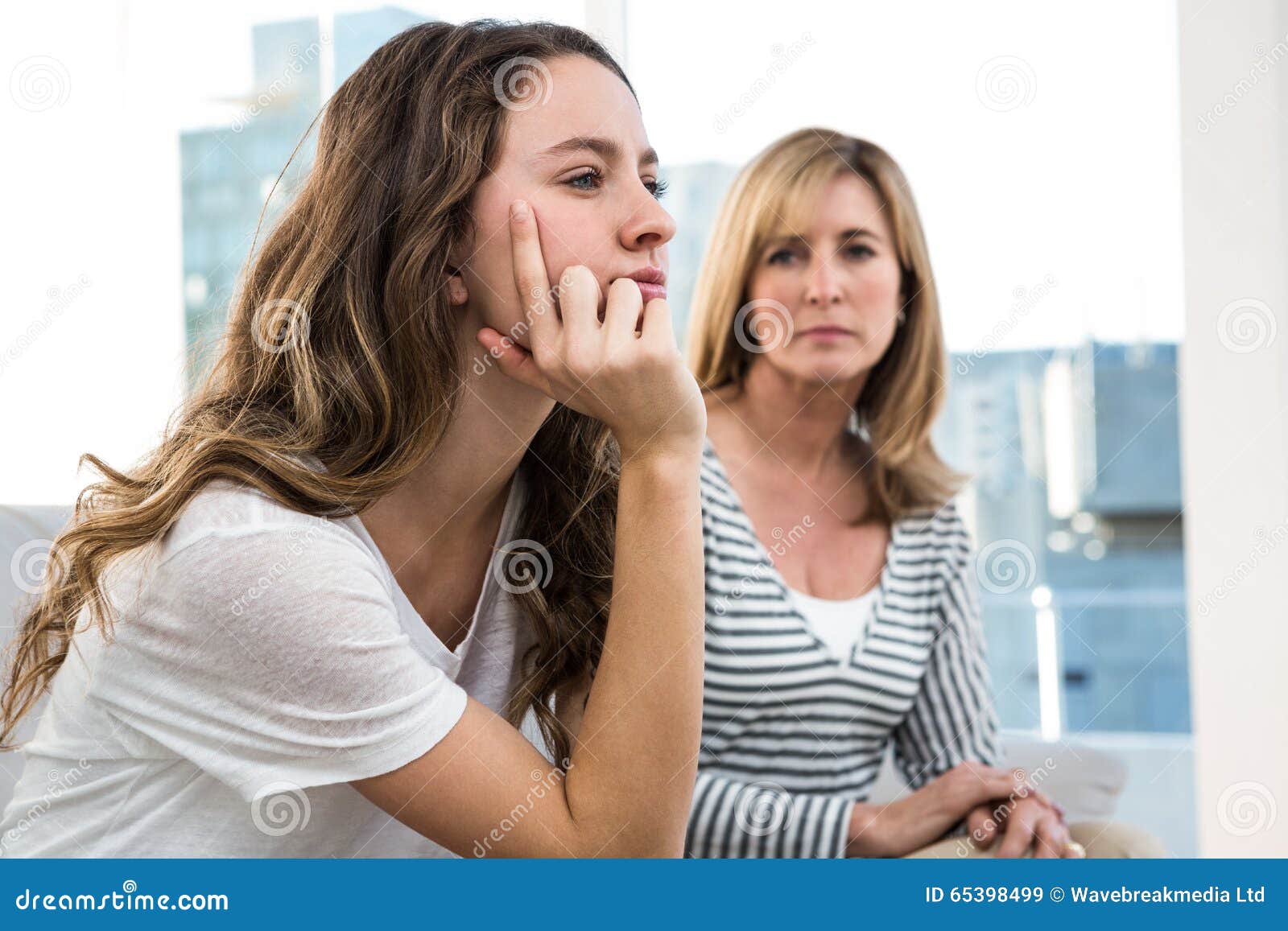 Daughter Thinking with Mother Stock Image - Image of indoors, chin ...