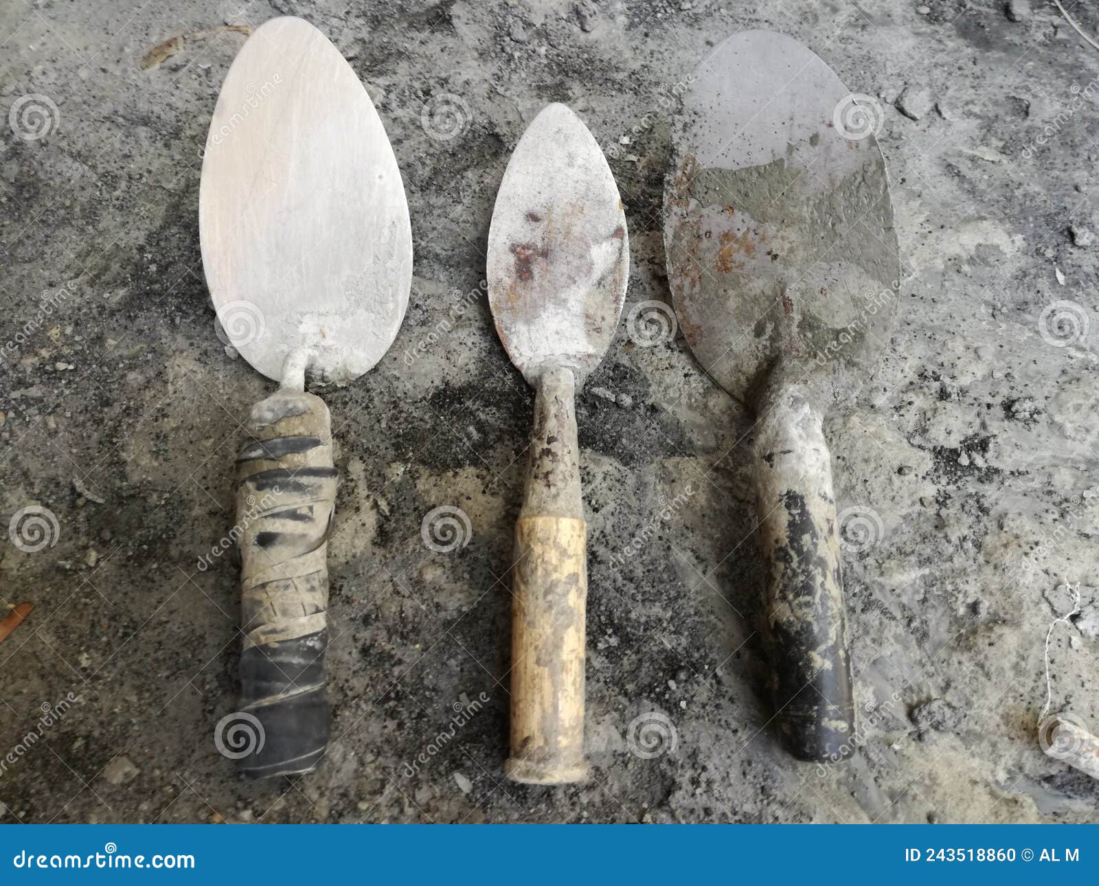 Three Spoons of Cement with Different Shape and Sizes , on a Cement ...