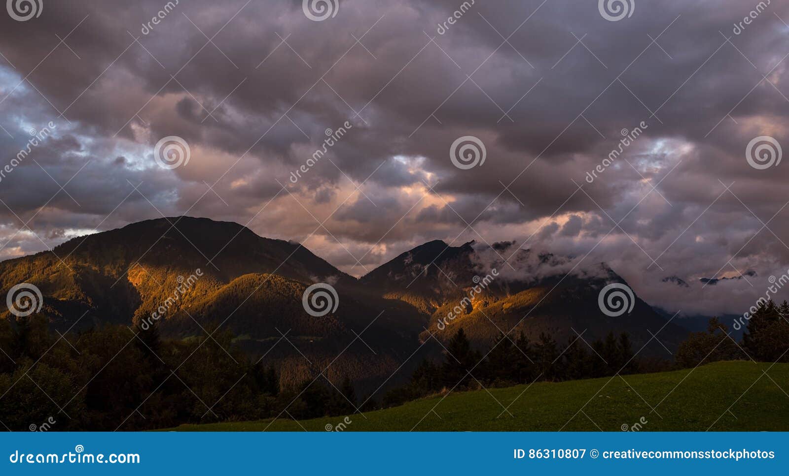 Dawn Through Clouds Over Mountain Peaks Picture. Image: 86310807