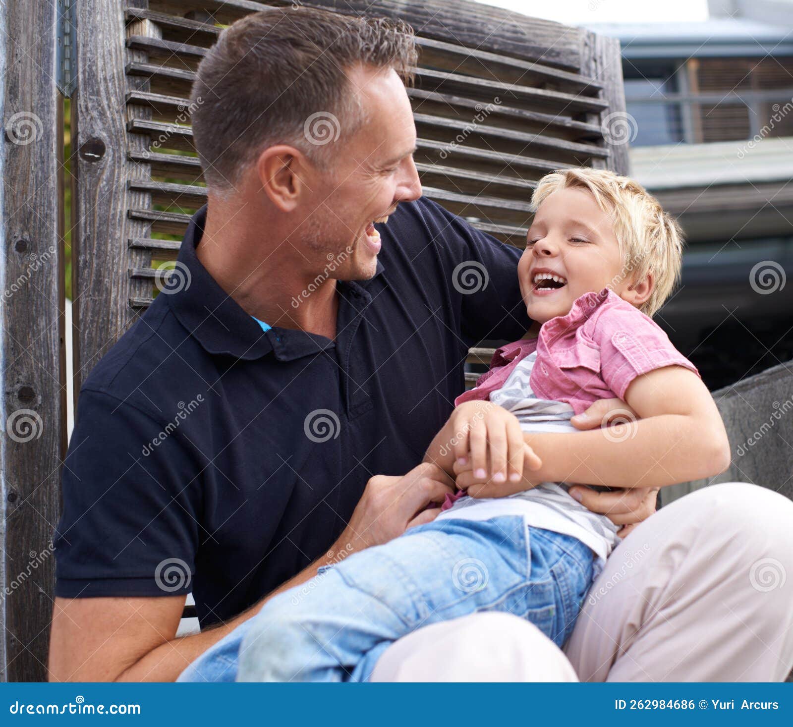 A Day Out with Dad. a Father and Son Sharing a Laugh while Sitting Outs ...