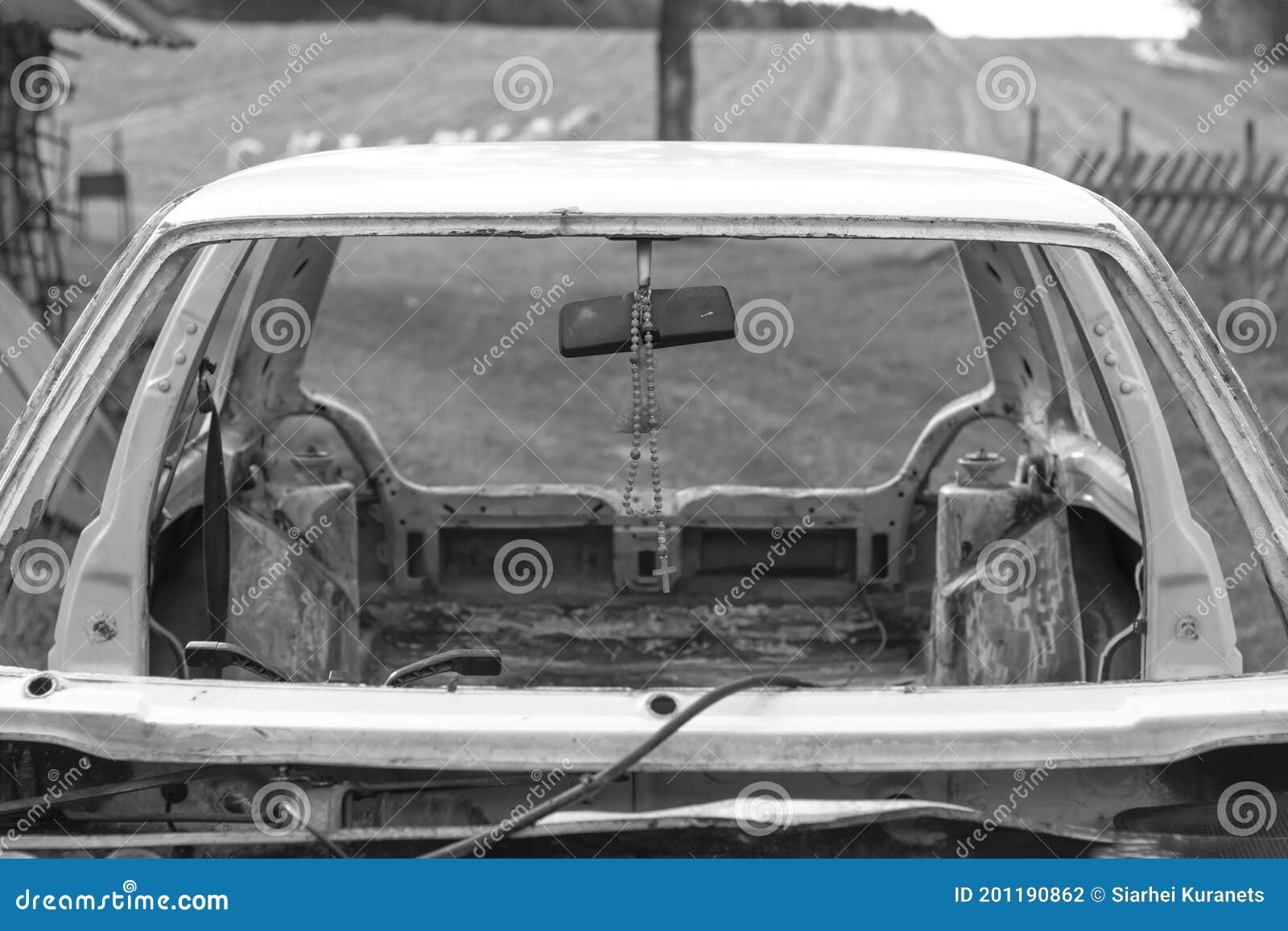 Daylight. Unassembled White Car. There is a Wooden Cross in the Center ...