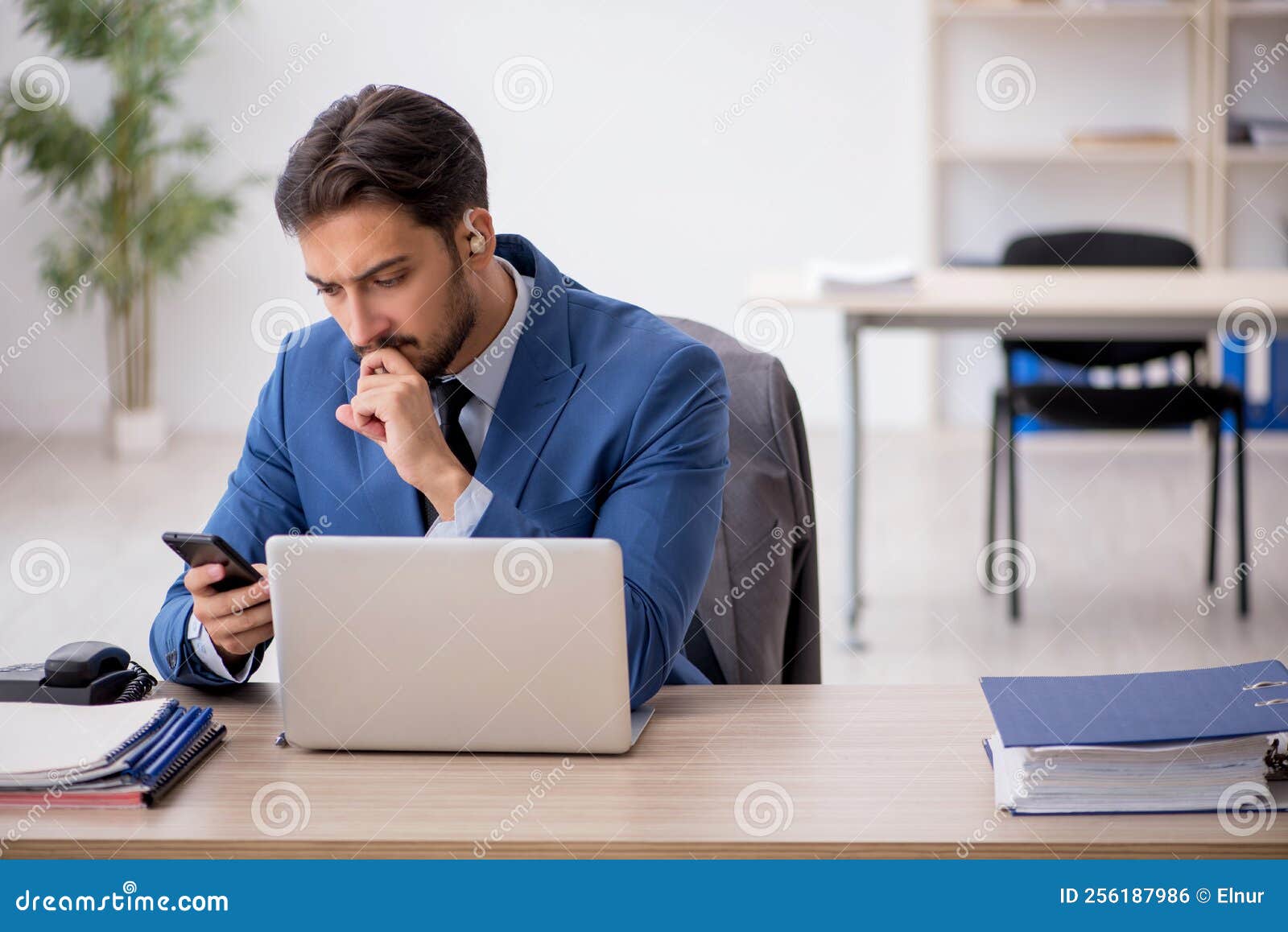 Deaf Male Employee Using Hearing Aid at Workplace Stock Photo - Image ...