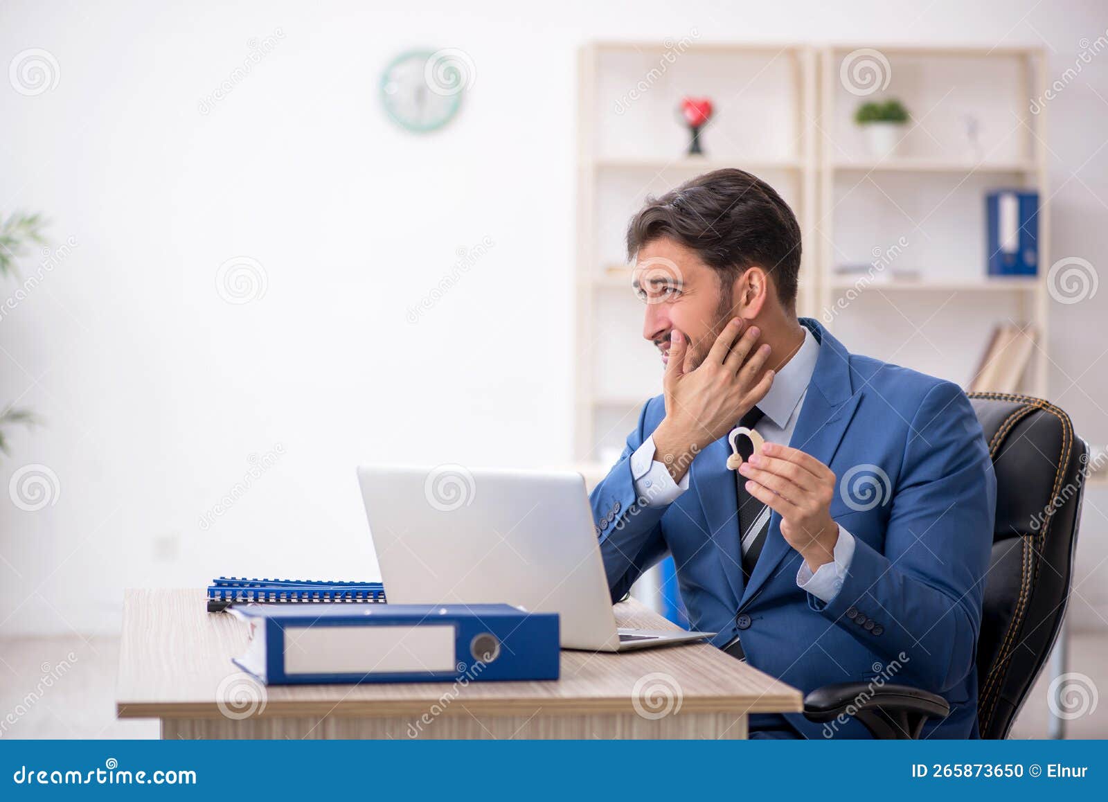 Deaf Male Employee Using Hearing Aid at Workplace Stock Photo - Image ...