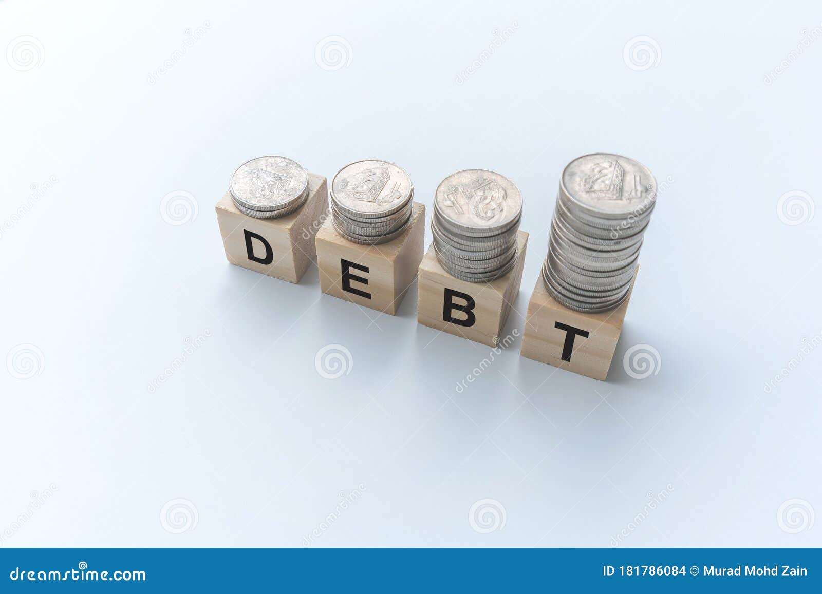 Debt Concept with Stacked Coins on Wooden Cube Stock Photo - Image of ...
