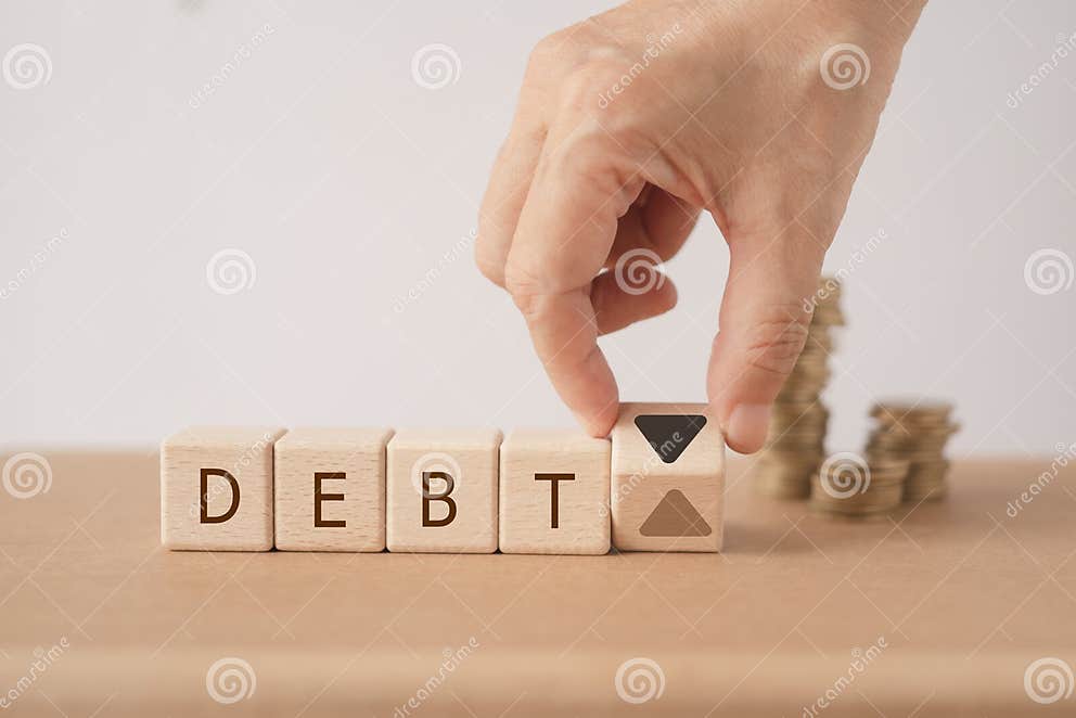 DEBT Word on Wooden Cube Blocks Word with Hand Flipped Up To Down Arrow ...