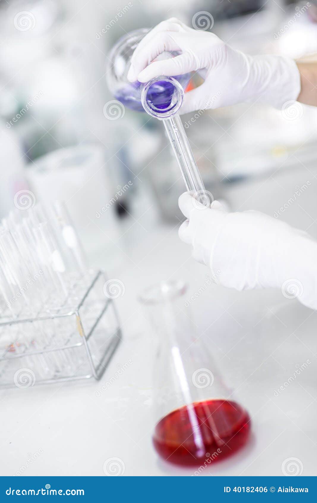 Decanting a Violet Liquid into a Graduated Cylinder Stock Photo - Image ...